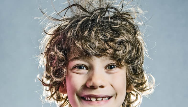 Little boy with static hair lighting a lightbulb - Futurity