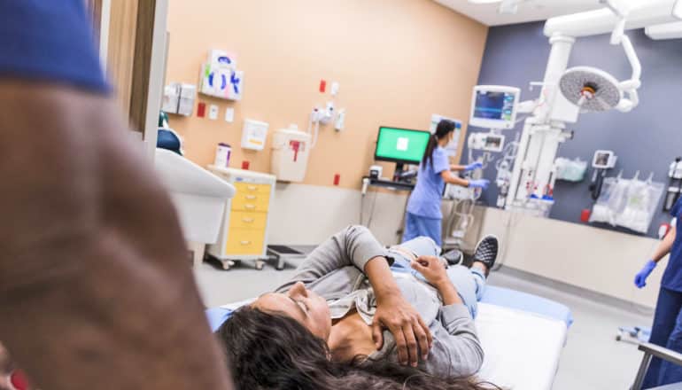 Rear view of female patient on the gurney - Futurity