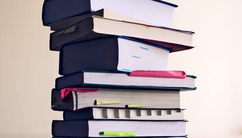 Textbooks stacked on table - Futurity